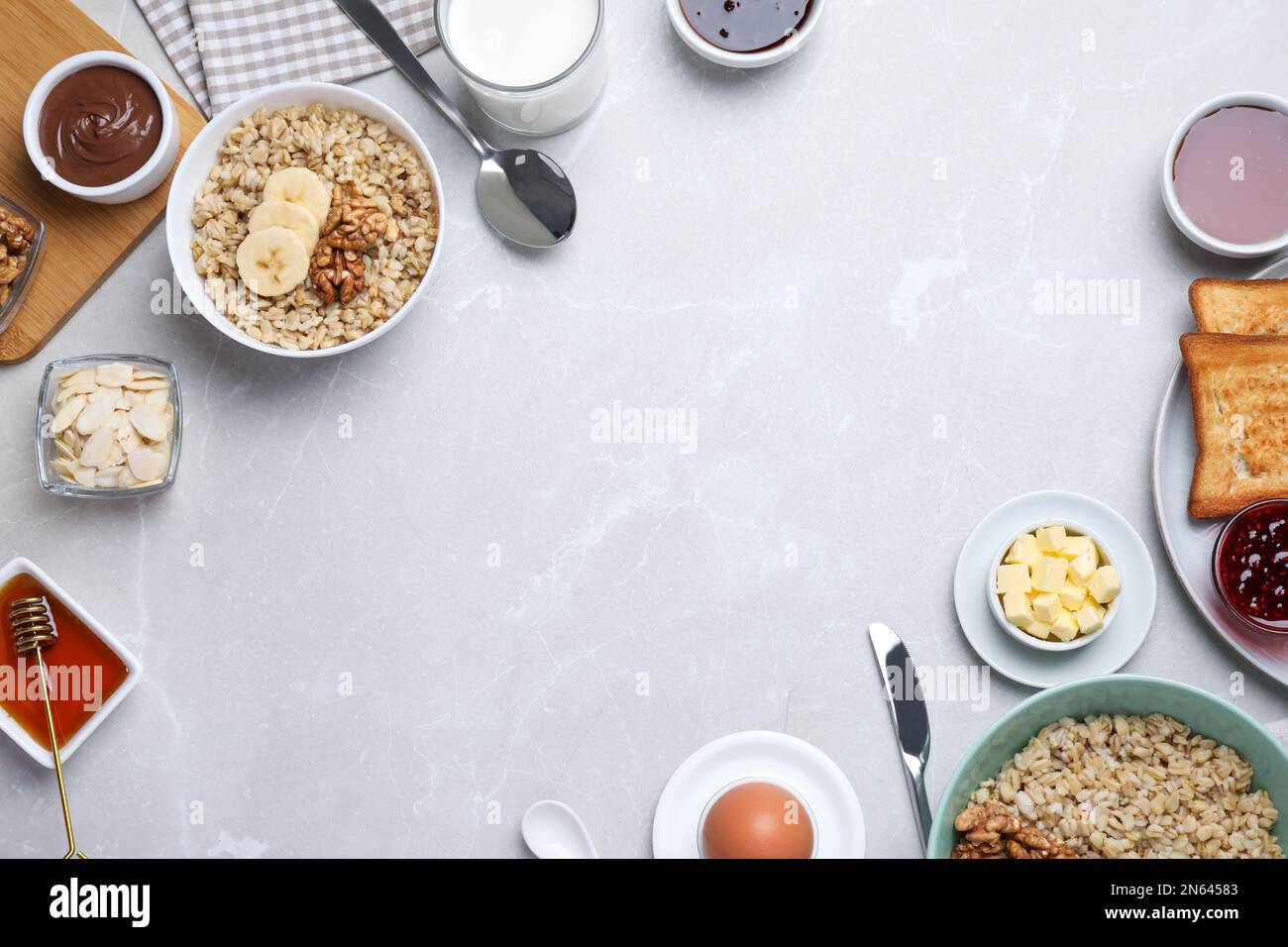 Flat lay composition with tasty breakfast food on light grey marble ...