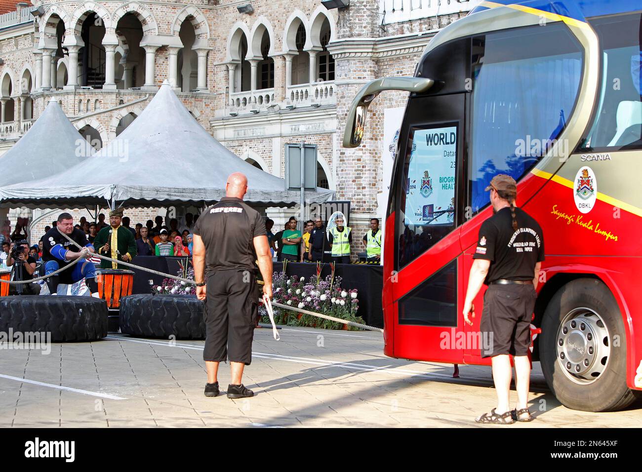 Lithuania's Zydrunas Savickas, left, competes in Bus Pull event at the ...