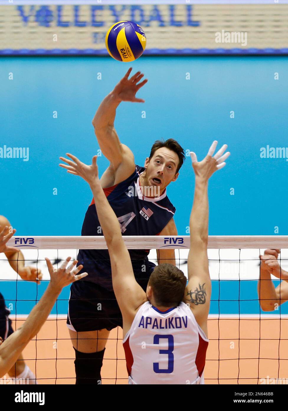 David Lee of the U.S. spikes against Nikolay Apalikov of Russia during ...