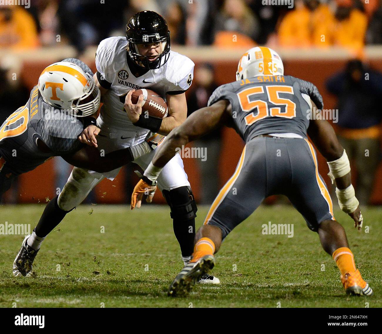 Vanderbilt quarterback Patton Robinette (4) is brought down by ...