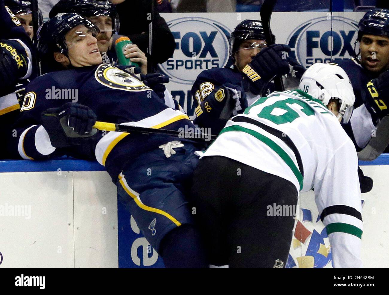 St. Louis Blues' Alexander Steen, left, is checked into the boards by ...