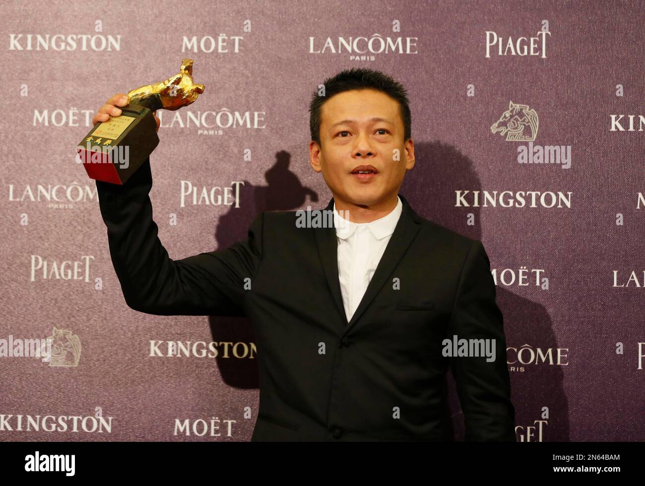 Best Leading Actor Lee Kang Sheng holds his award for his film " Stray ...