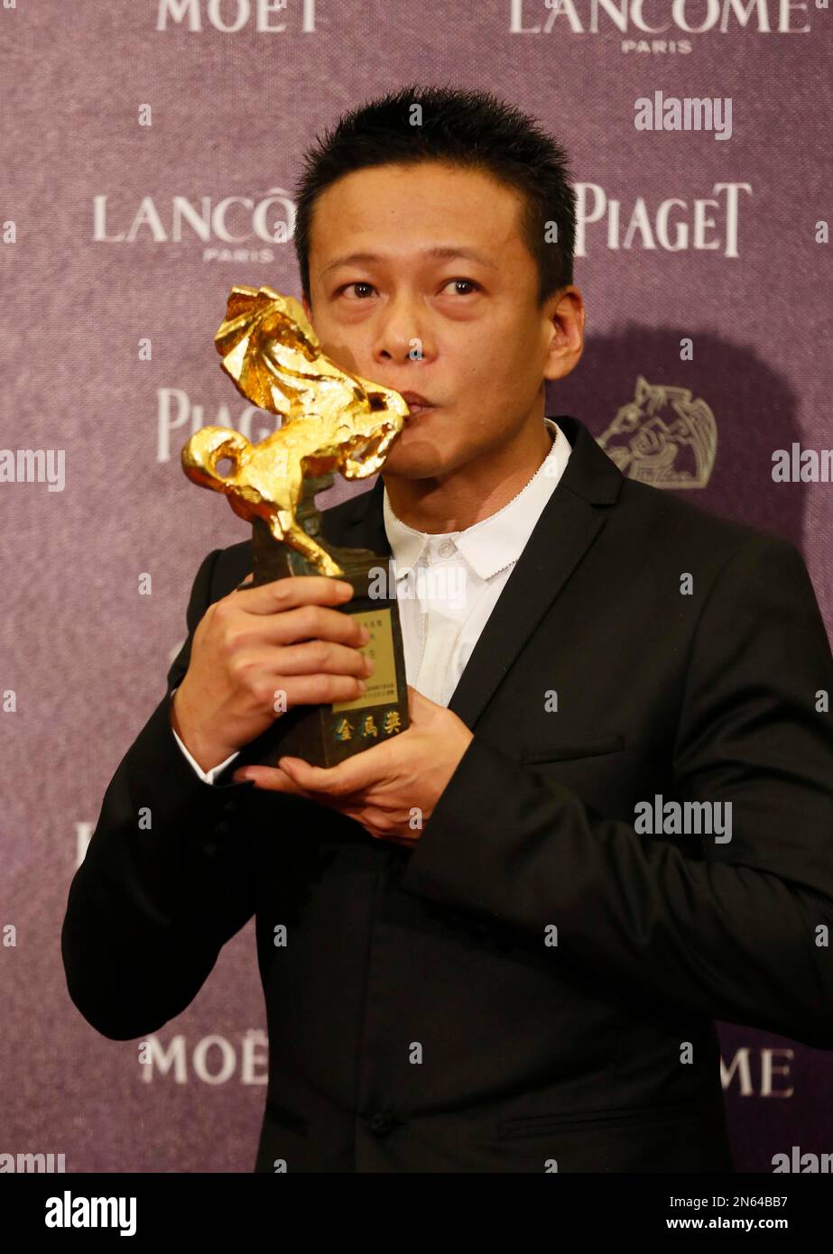 Best Leading Actor Lee Kang Sheng holds his award for his film " Stray ...
