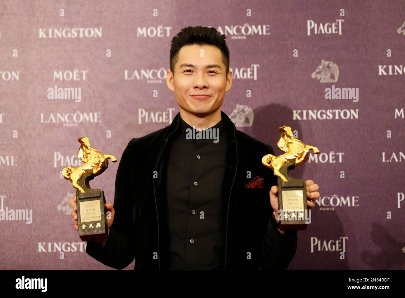 Singapore director Anthony Chen holds his awards and poses for the ...