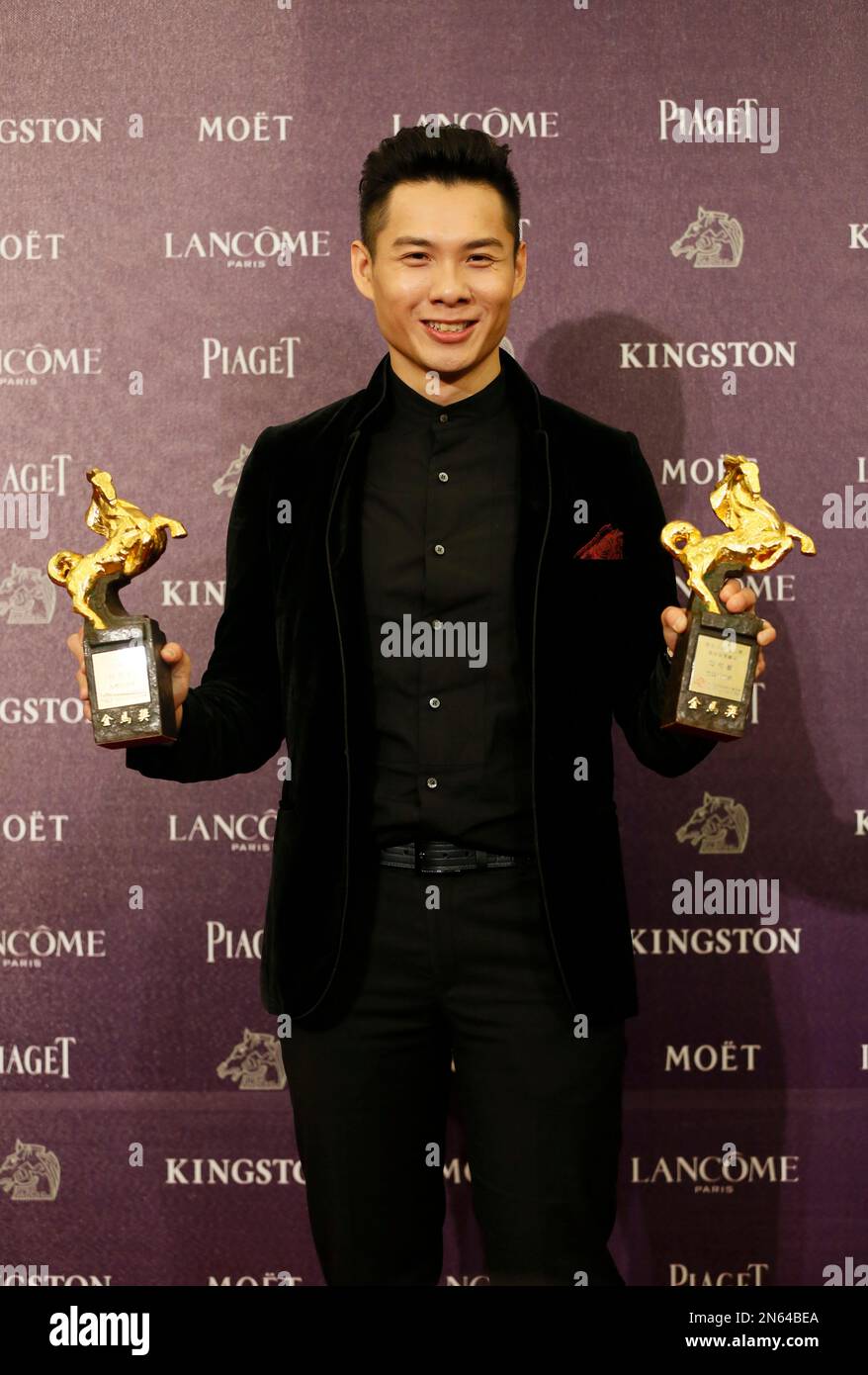 Singapore director Anthony Chen holds his awards and poses for media ...