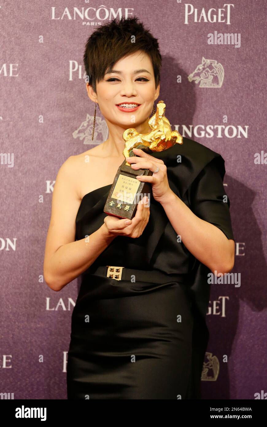 Singapore's actress Yeo Yann Yann, holding her trophy, poses for media for Best Supporting ...