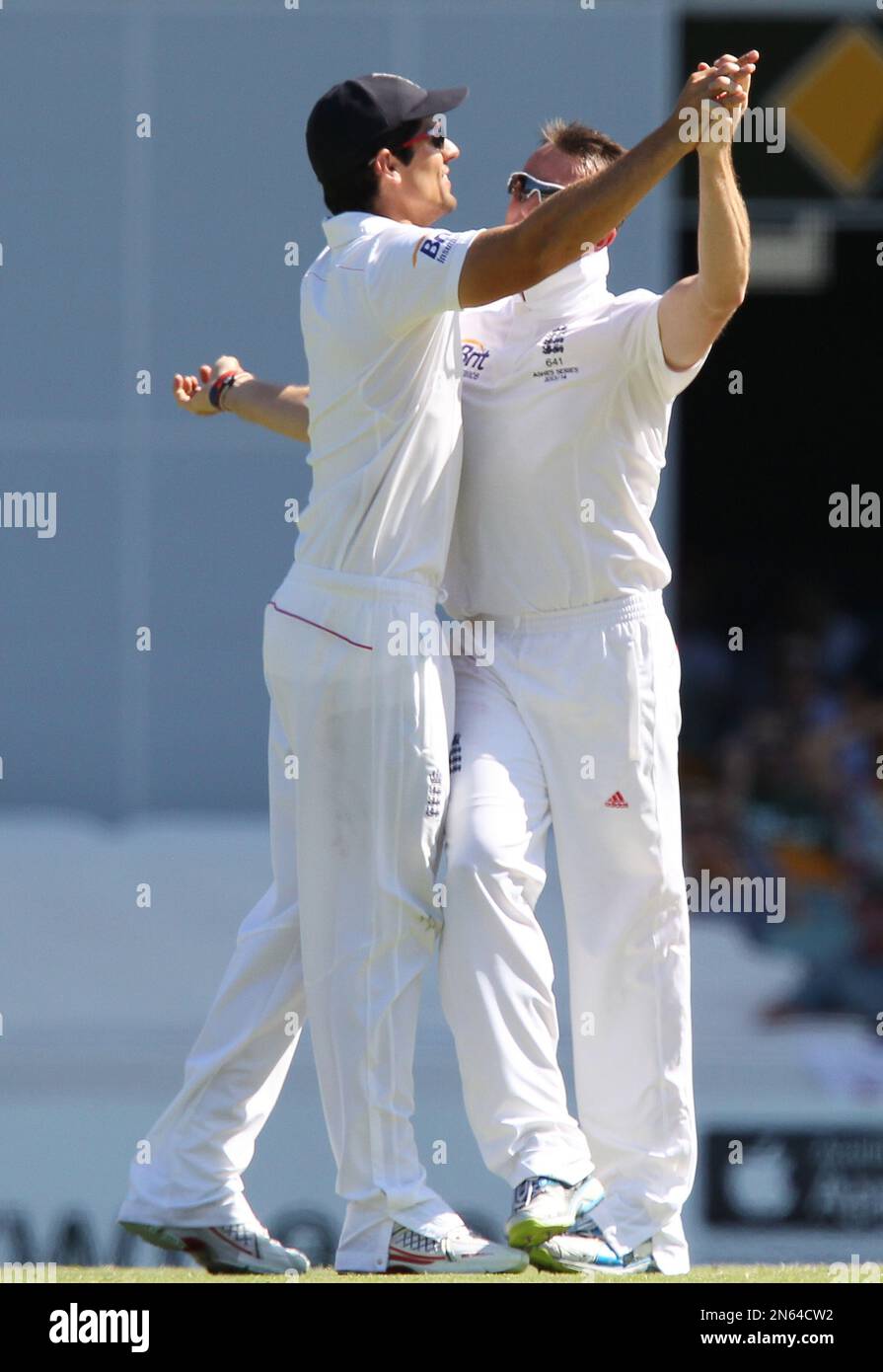 England's Alastair Cook, left, celebrates with teammate Graeme Swann ...
