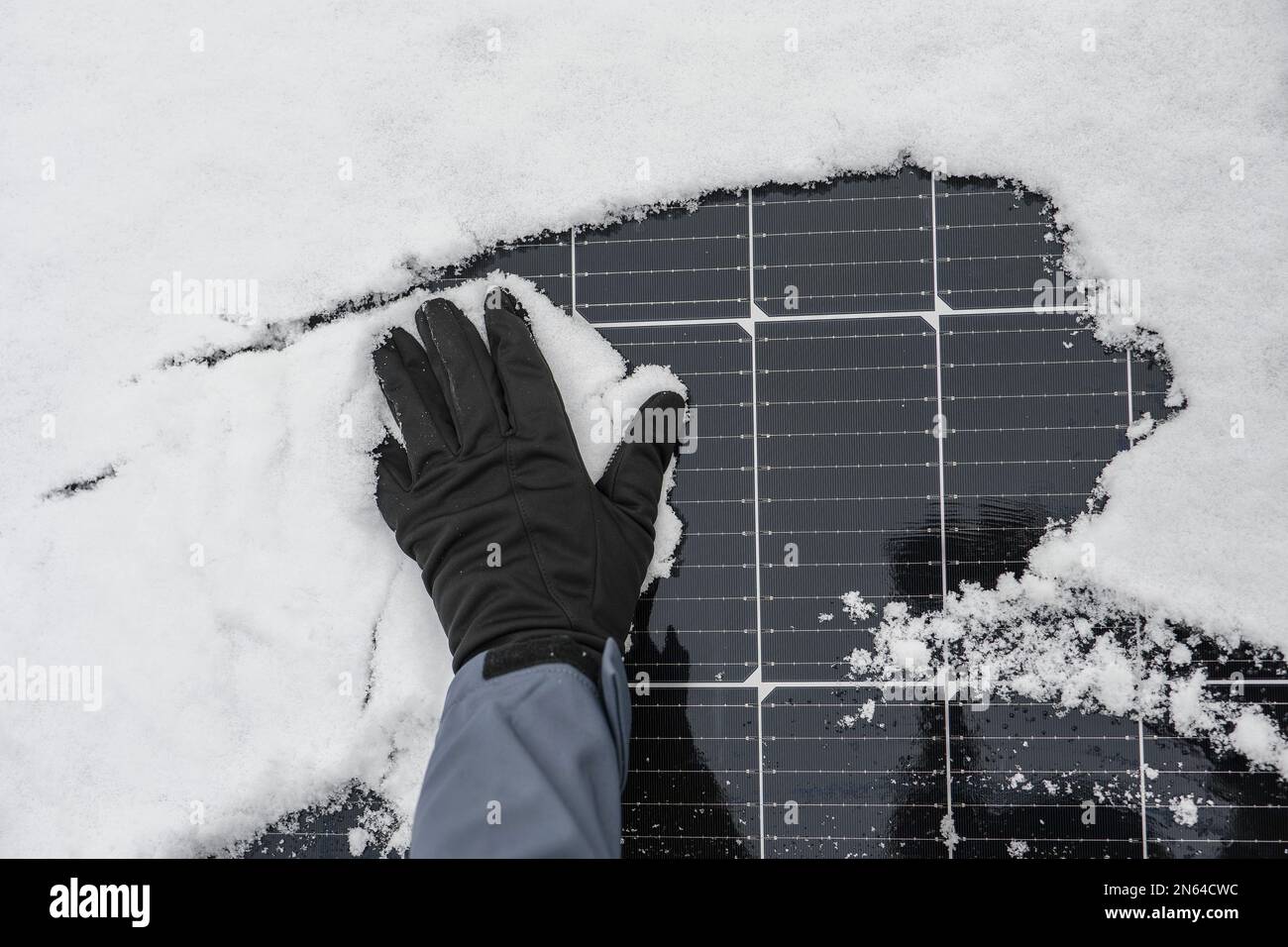 Solar energy.Getting electricity with solar panels in winter.Hands in ...