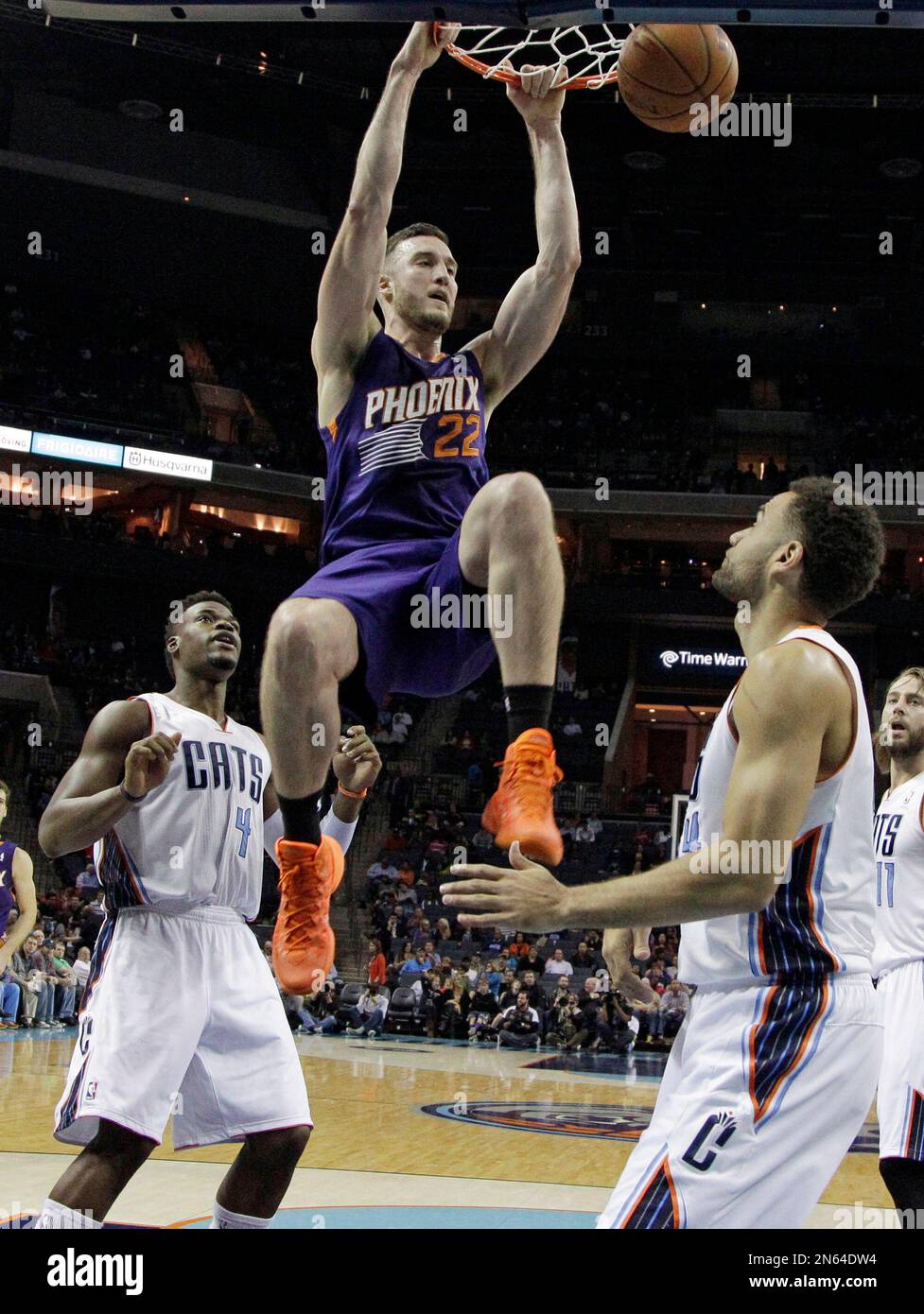 Phoenix Suns' Miles Plumlee, center, dunks as Charlotte Bobcats' Jeff ...
