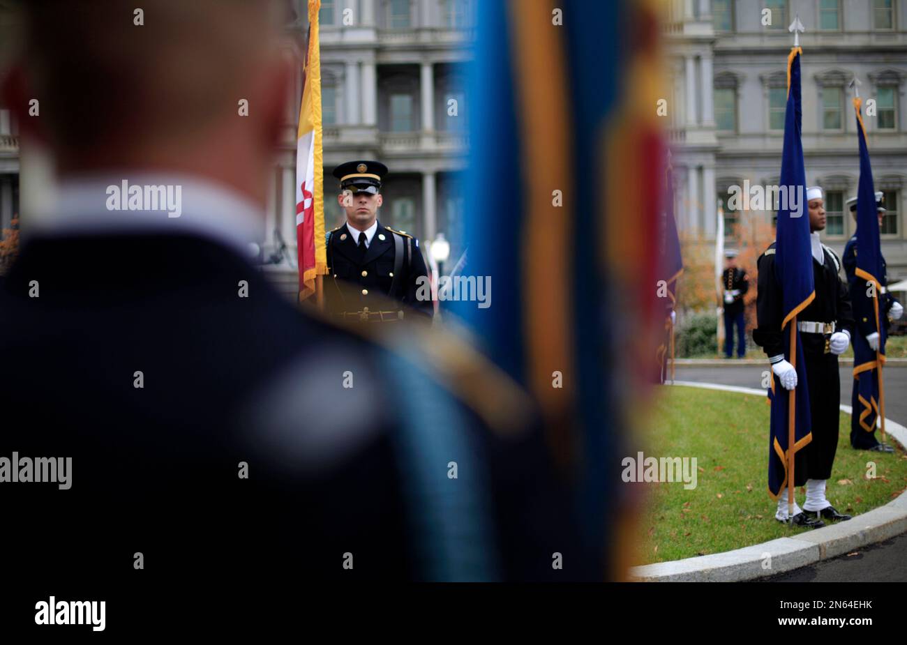 Military honor guard members position themselves in an honor cordon ...