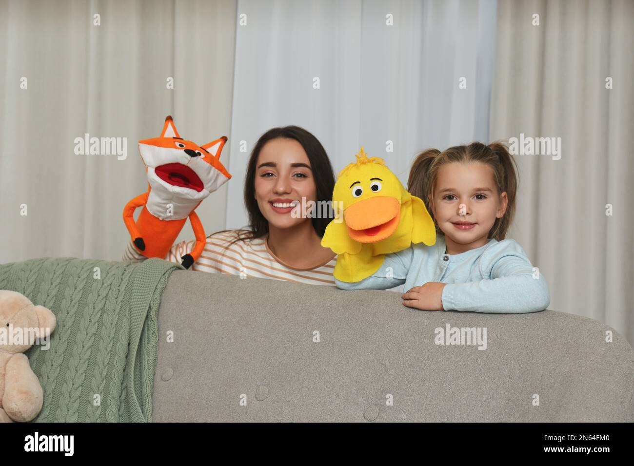 Mother and daughter performing puppet show at home Stock Photo - Alamy