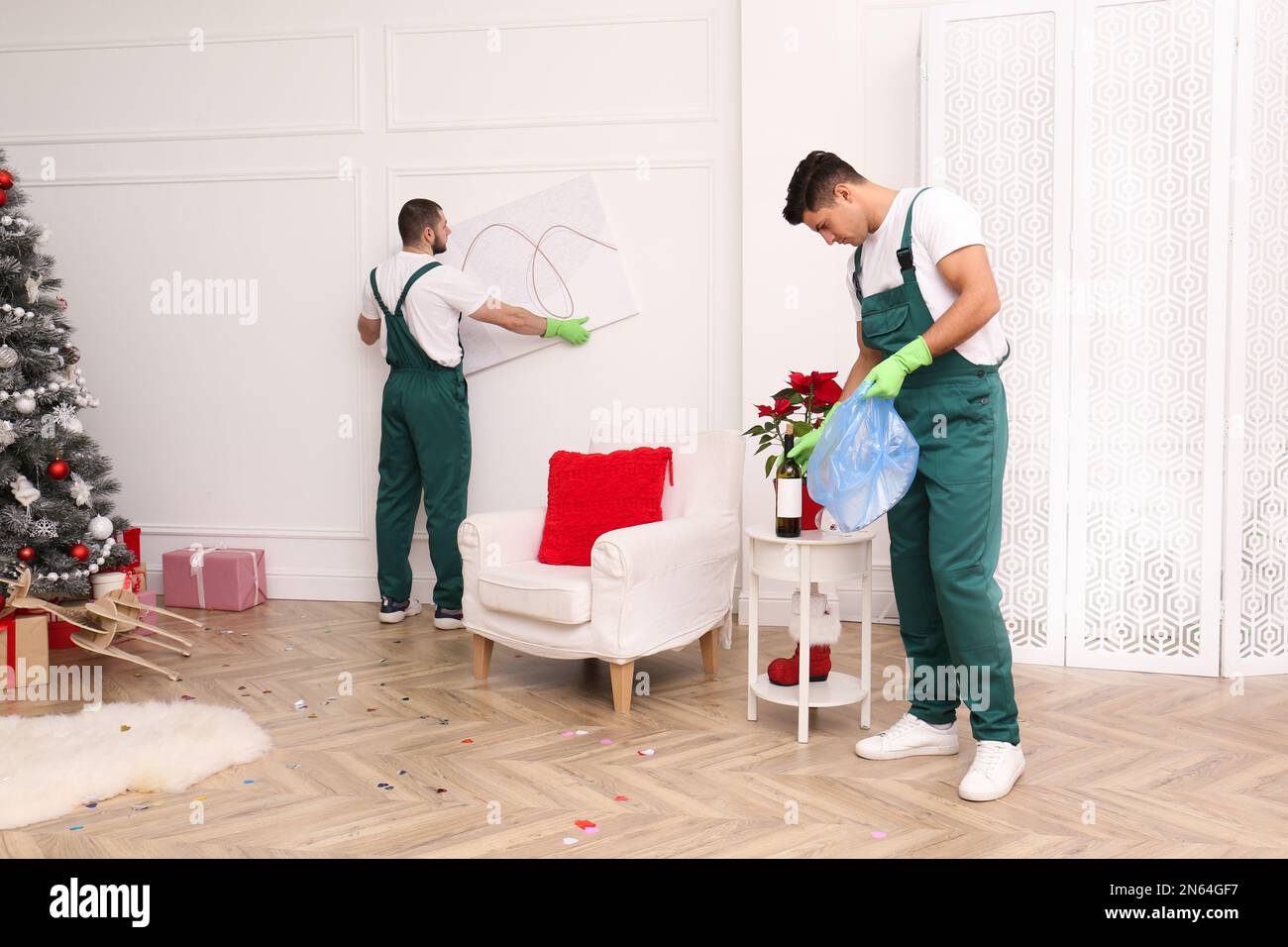 Cleaning service team working in messy room after New Year party Stock ...