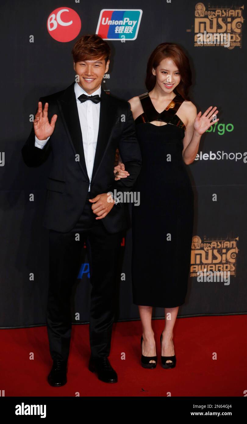 South Korean singer Kim Jong-kook, left, and actress Song Ji-hyo pose for photographers on the ...
