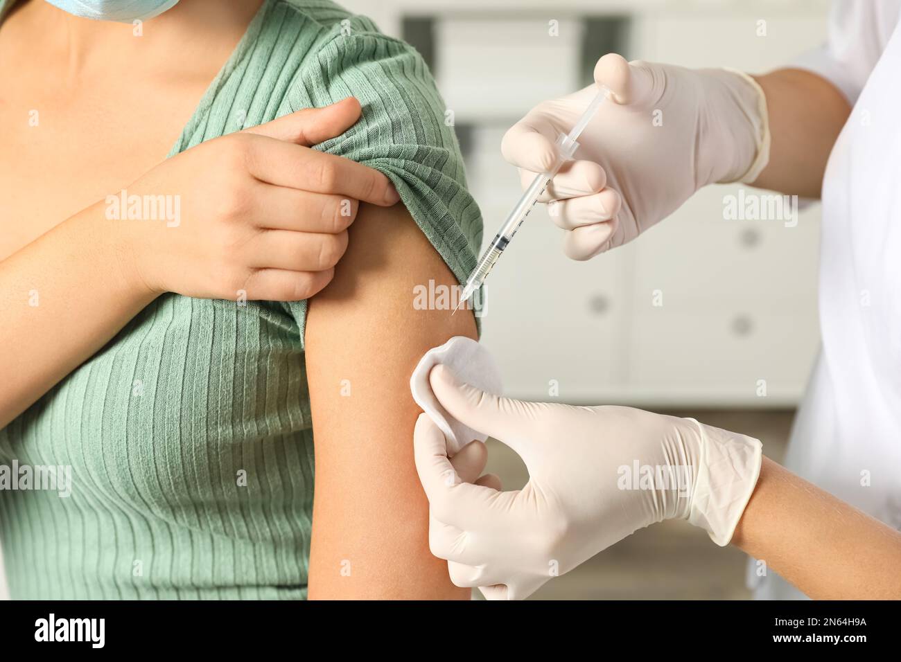 Doctor giving injection to patient in hospital, closeup. Vaccination ...