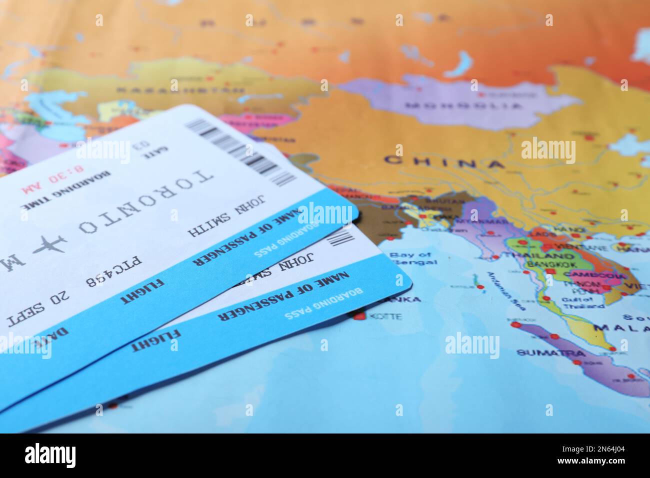 Avia tickets on world map, closeup. Travel agency concept Stock Photo ...