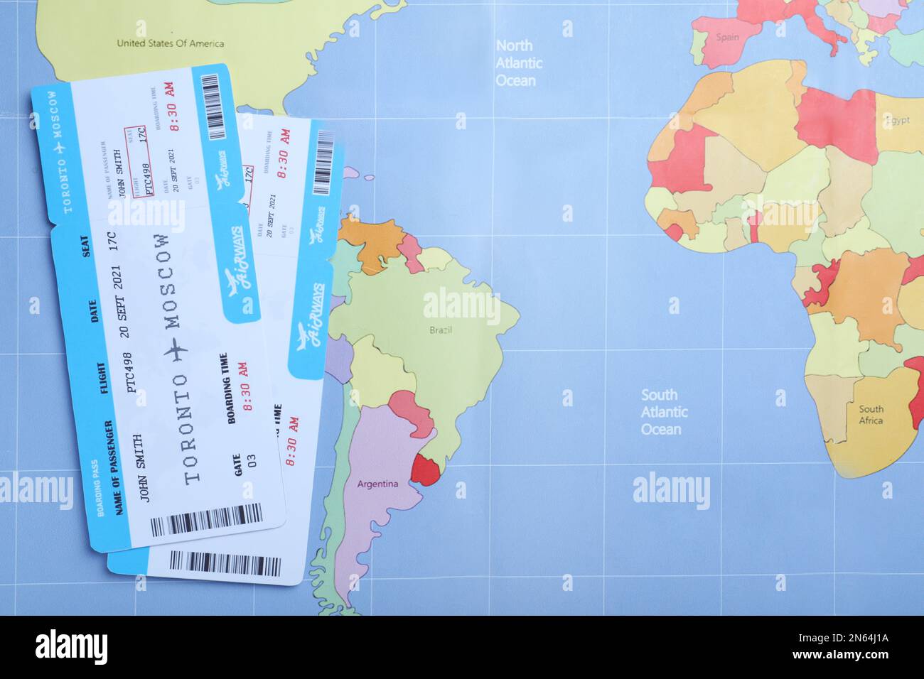 Tickets on world map, flat lay. Travel agency concept Stock Photo - Alamy