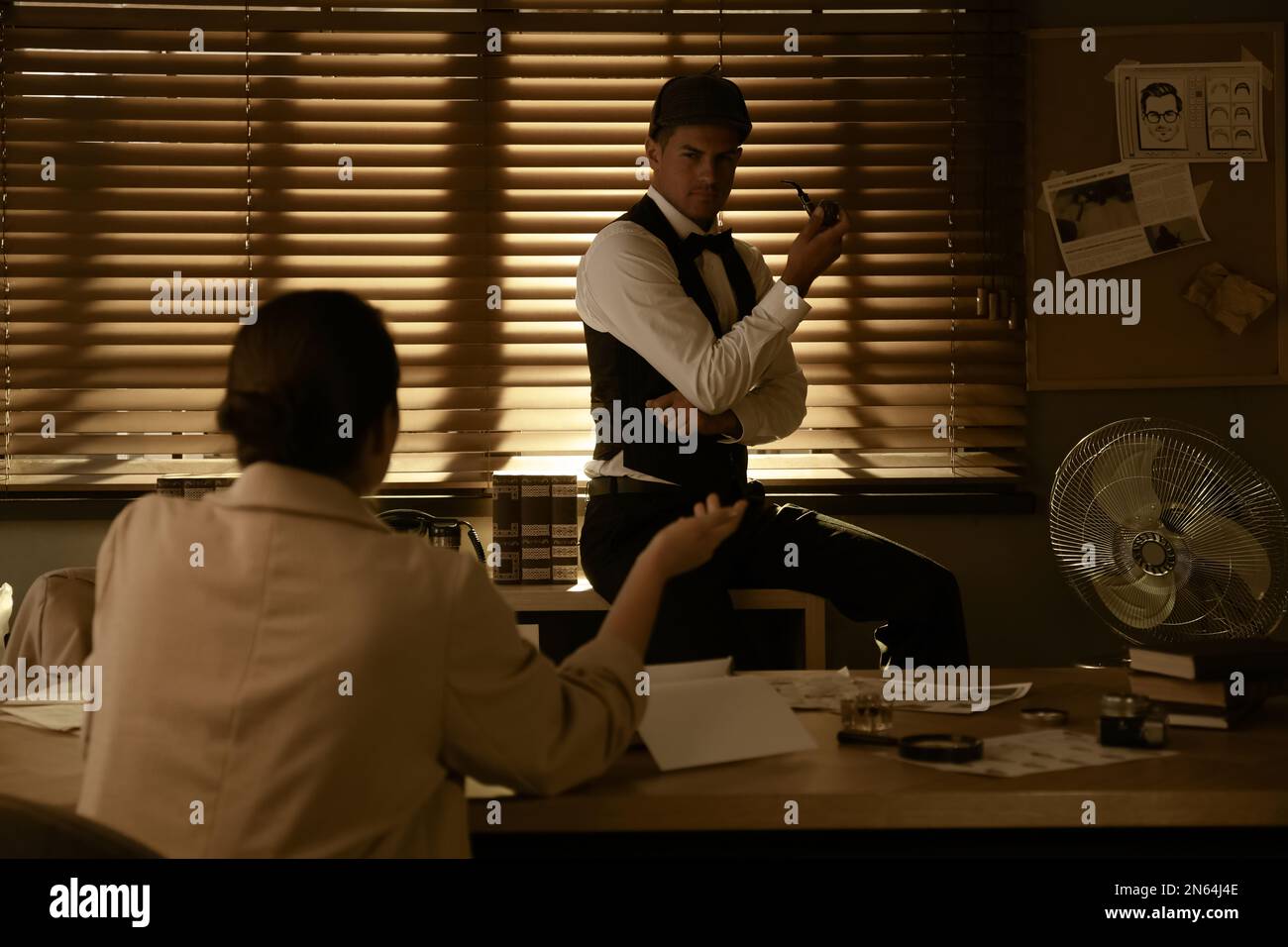 Old fashioned detective working with client in office Stock Photo - Alamy