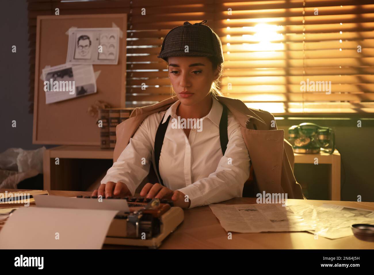 Old fashioned detective using typewriter at table in office Stock Photo ...
