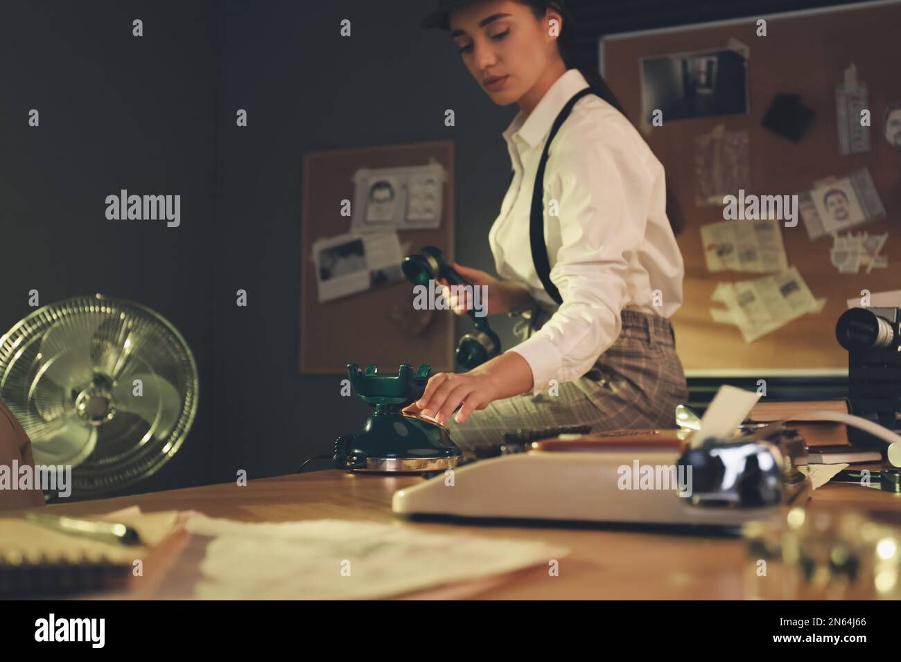 Old fashioned detective dialing telephone number in office Stock Photo ...