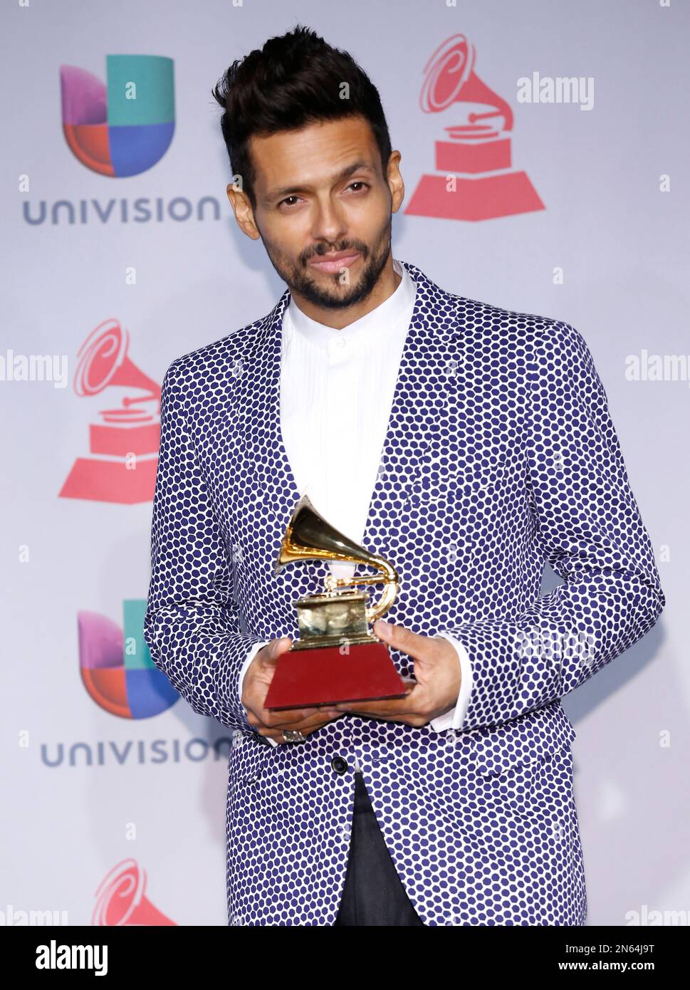 Draco Rosa poses with the award for album of the year for "Vida ...