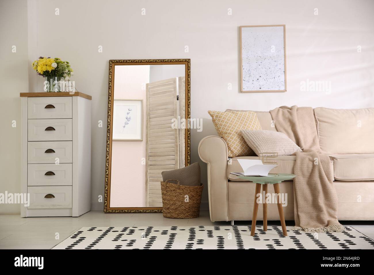 Large mirror and comfortable sofa in living room. Interior design Stock ...