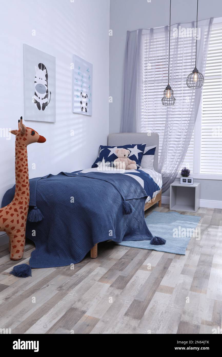 Bed with stylish linens in children's room. Interior design Stock Photo ...