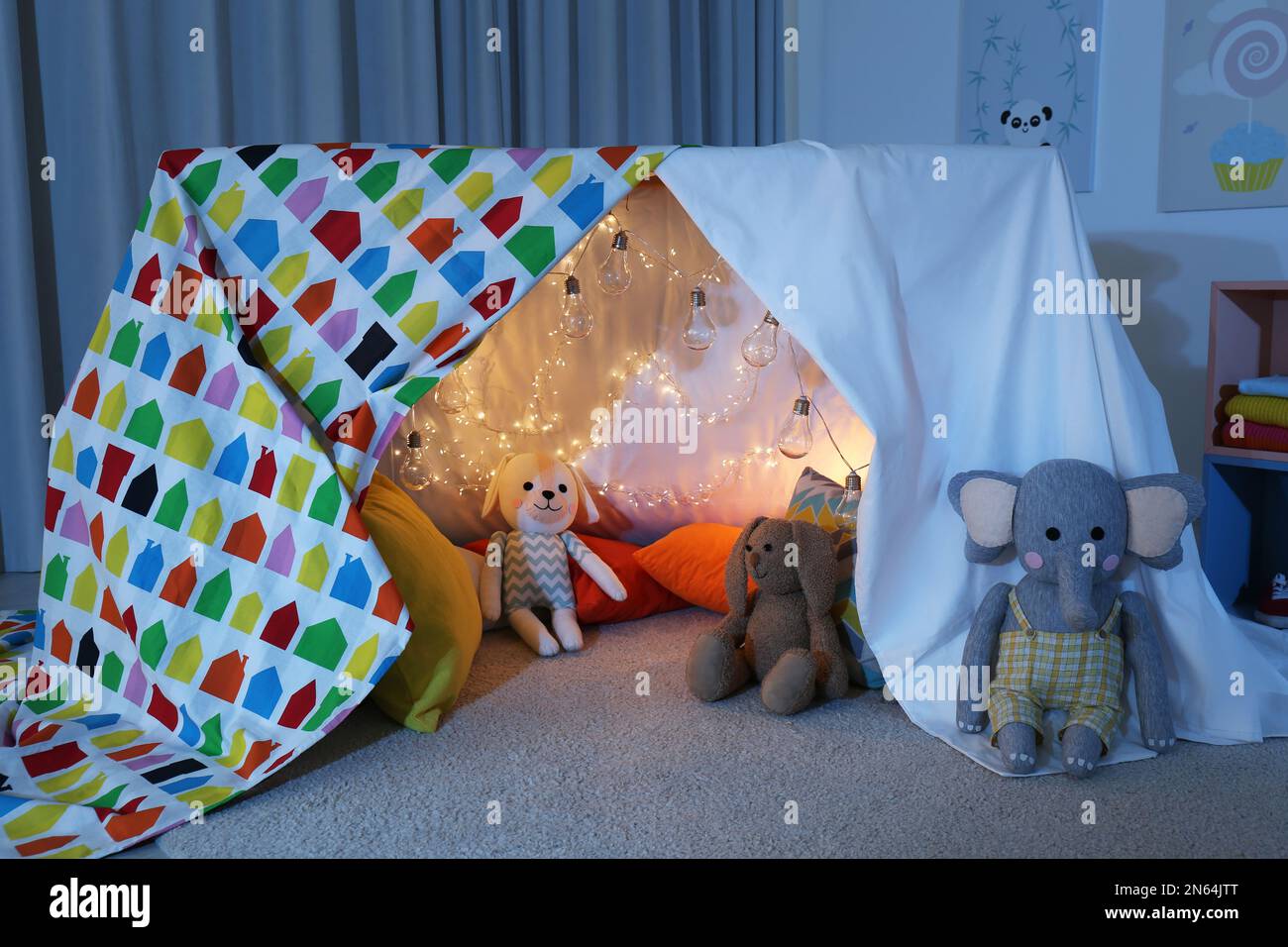 Play tent decorated with festive lights in modern child's room Stock ...