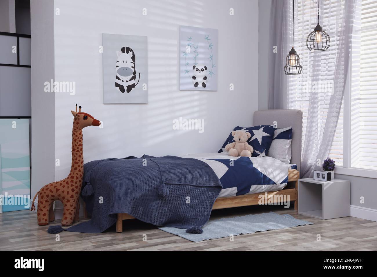 Bed with stylish linens in children's room. Interior design Stock Photo ...