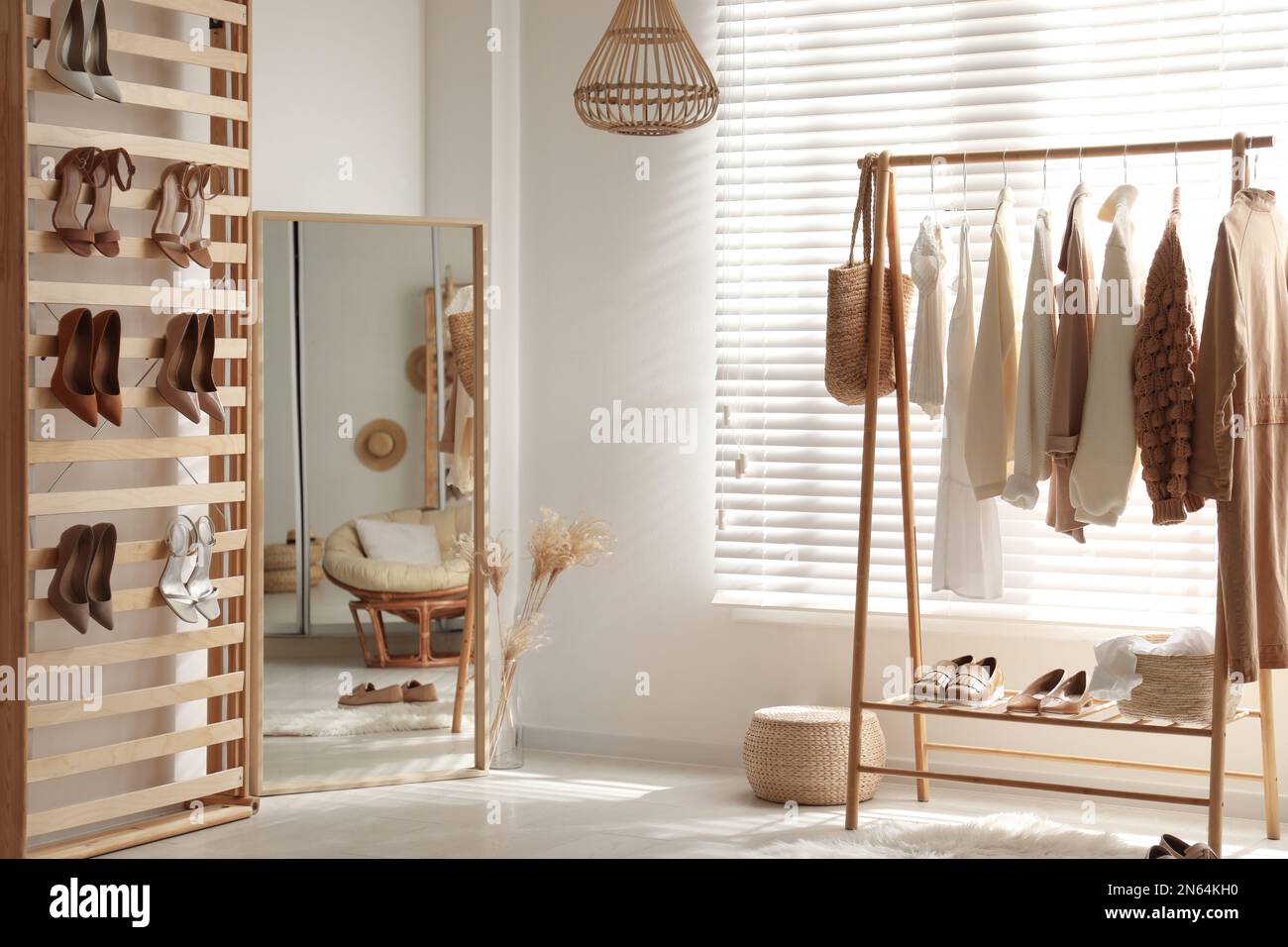 Modern dressing room interior with racks of stylish women's clothes and ...