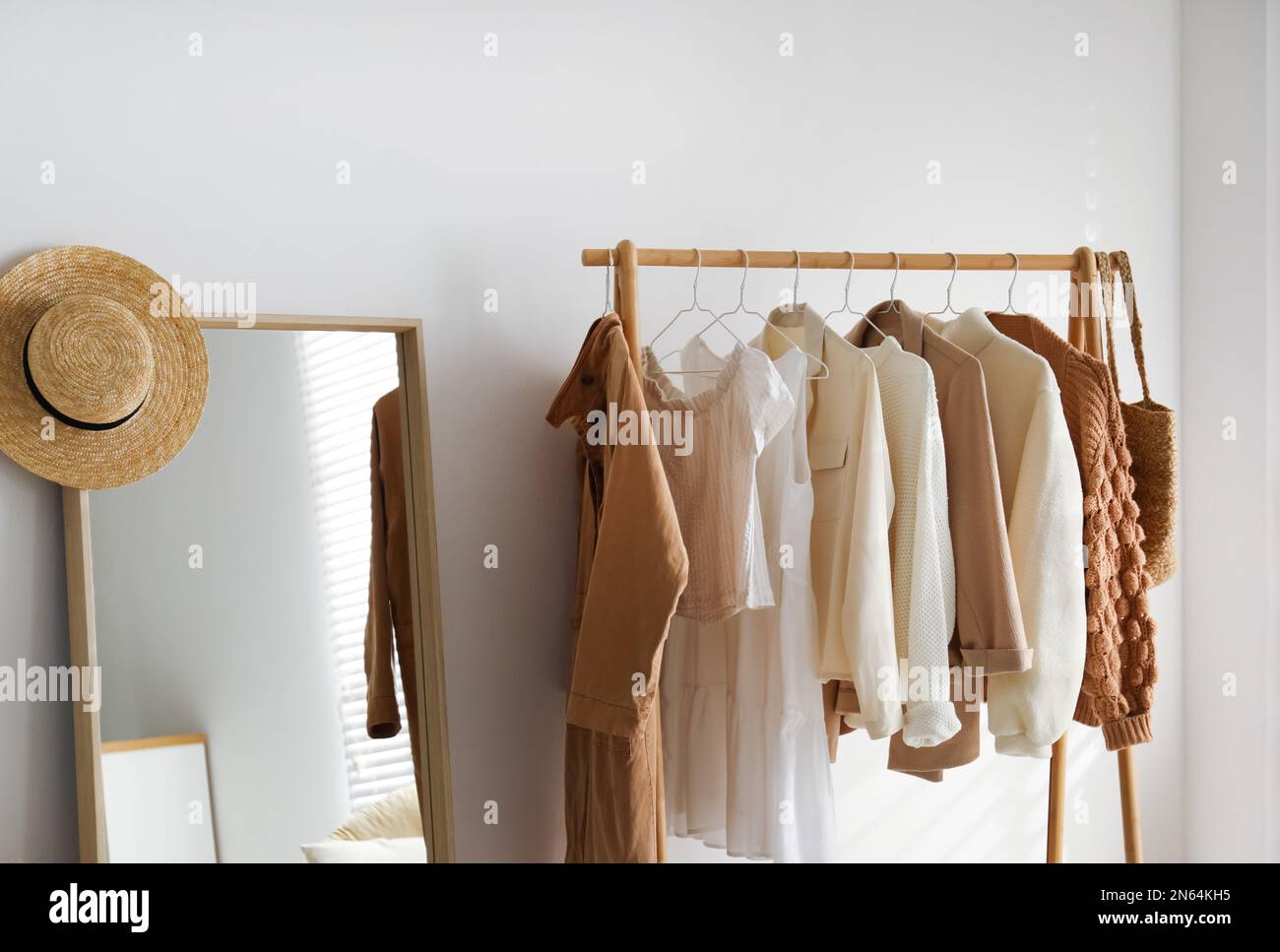 Rack with stylish women's clothes in dressing room. Modern interior ...