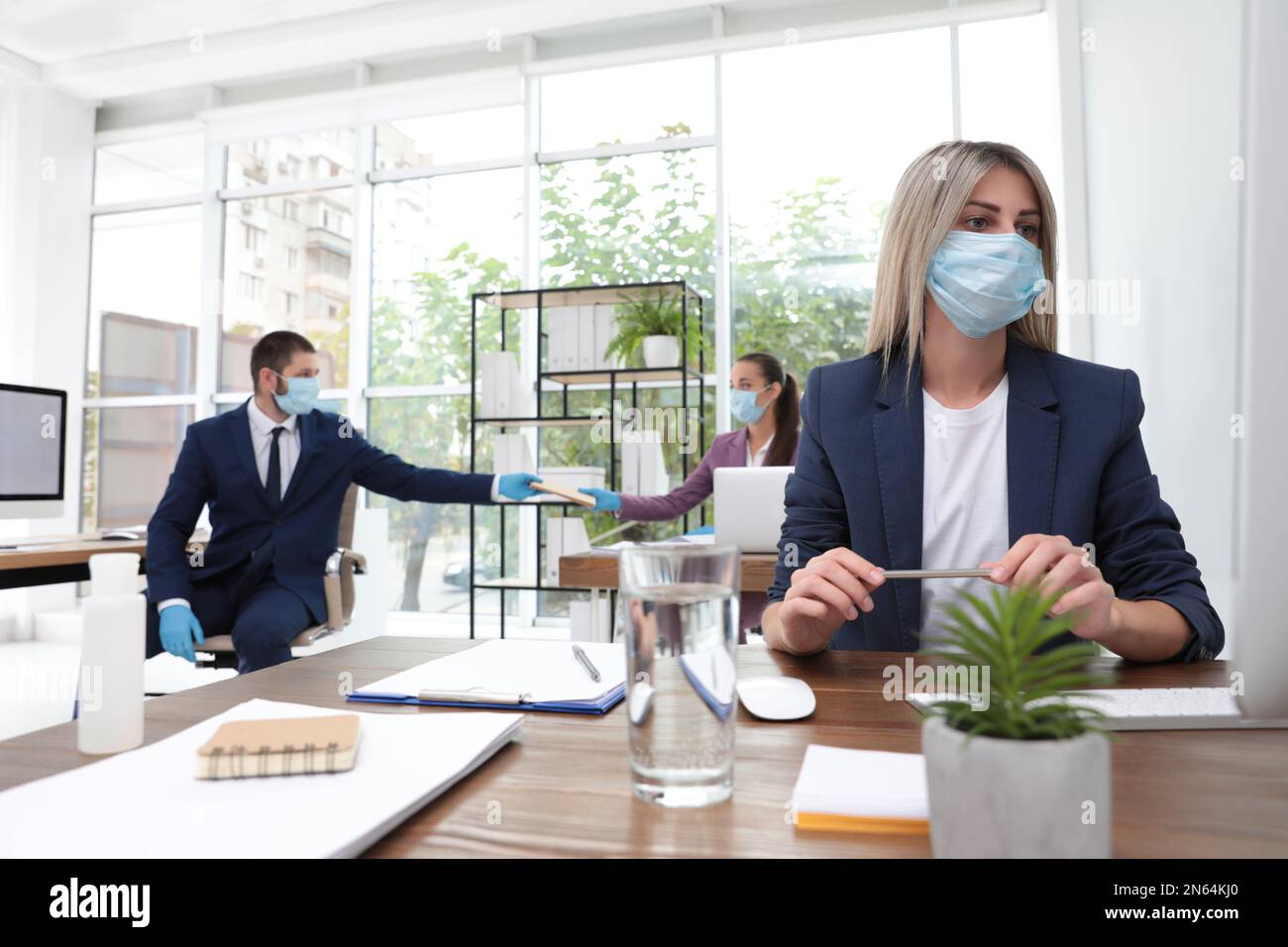 Office employees in respiratory masks at workplace Stock Photo - Alamy