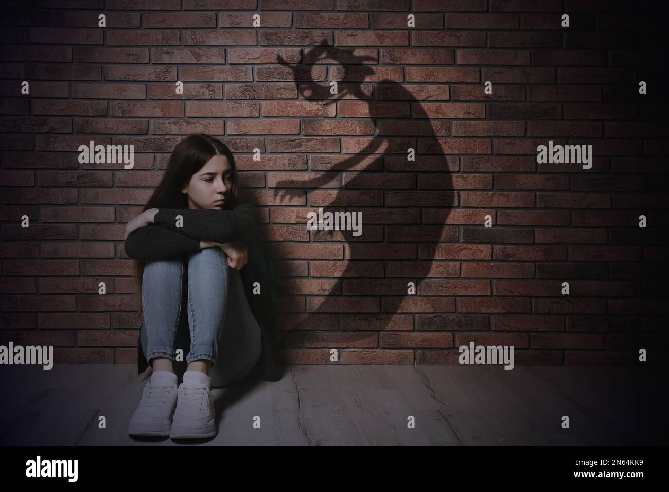 Shadow of monster on wall and scared teenage girl in room Stock Photo ...