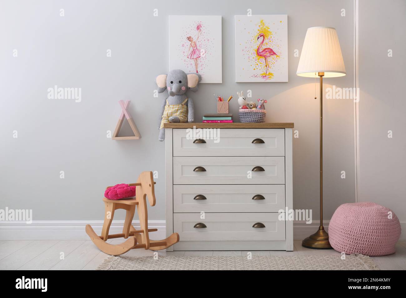 Chest of drawers and beautiful pictures in children's room. Interior ...