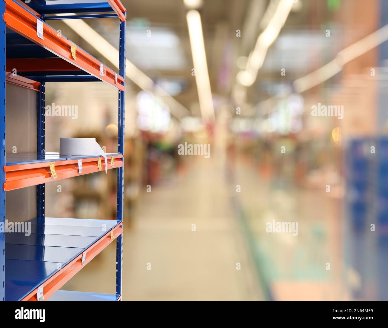 Almost empty shelves in supermarket, closeup. Product deficiency due to ...