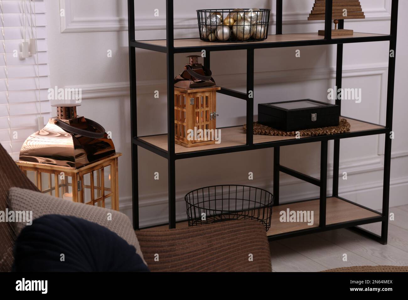 Stylish shelving unit with different decor near white wall indoors ...