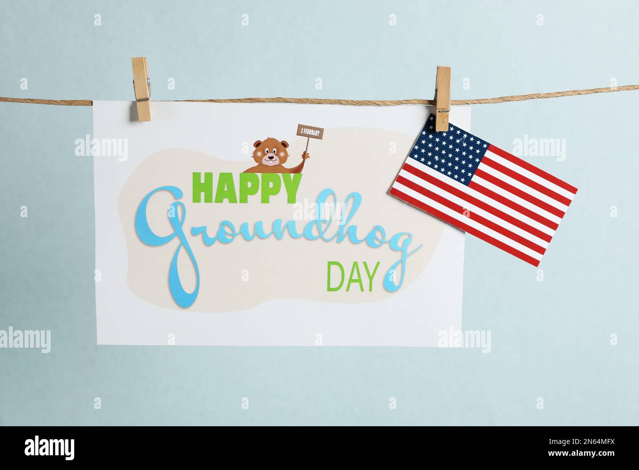 Happy Groundhog Day greeting card and American flag hanging on light ...