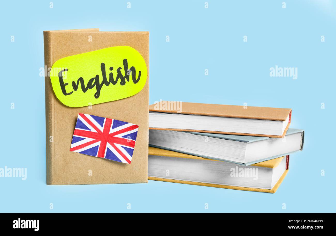 Word English and stack of books on light blue background Stock Photo ...