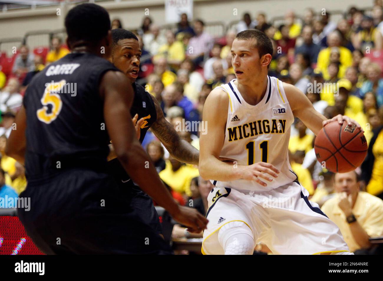 Long Beach State’s Mike Caffey, left, and Kris Gulley pressure Michigan ...