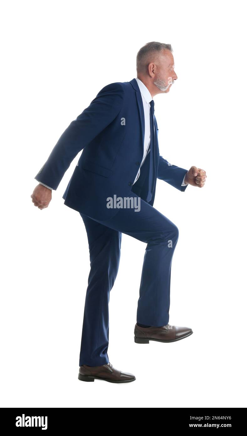 Businessman imitating stepping up on stairs against white background ...