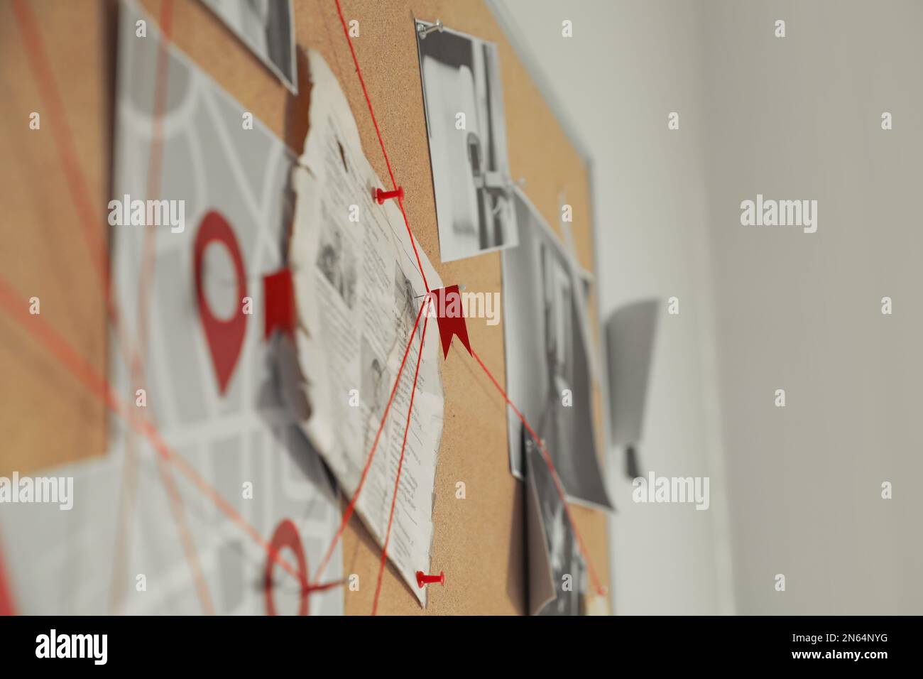 Detective board with crime scene photos and red threads, closeup Stock ...
