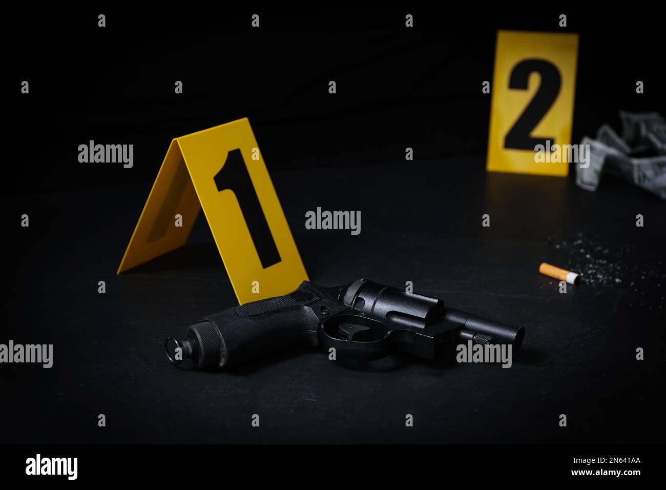 Crime scene markers and evidences on black background Stock Photo - Alamy