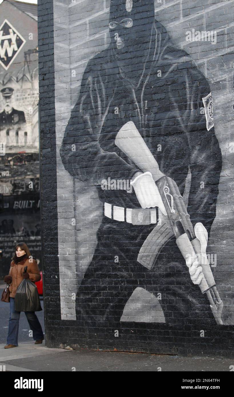 A loyalist mural showing a paramilitary gunman adorns a wall in East ...