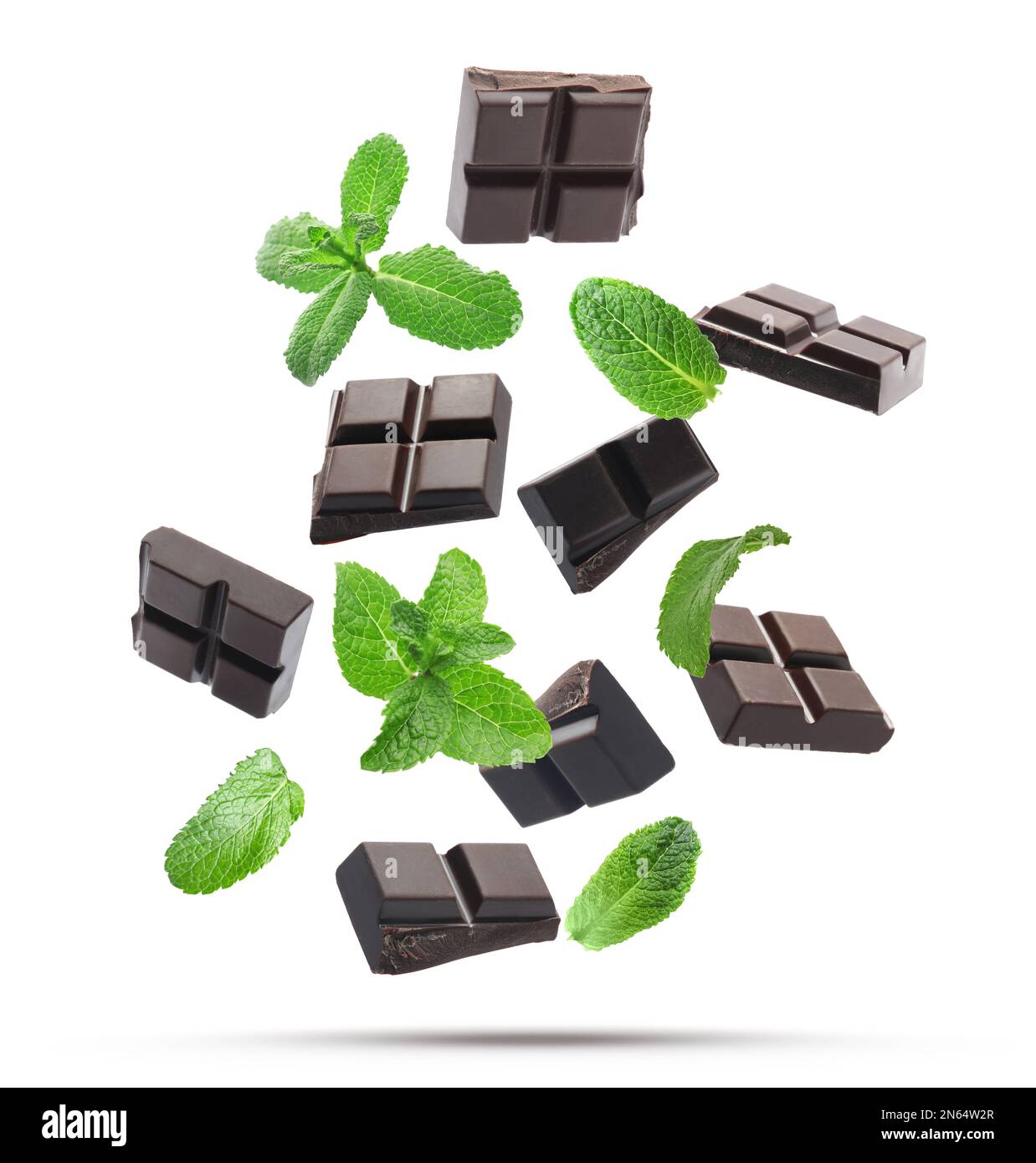Black chocolate pieces and mint falling on white background Stock Photo ...