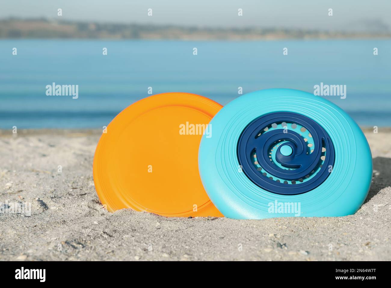 Plastic frisbee discs on sandy beach near river Stock Photo - Alamy