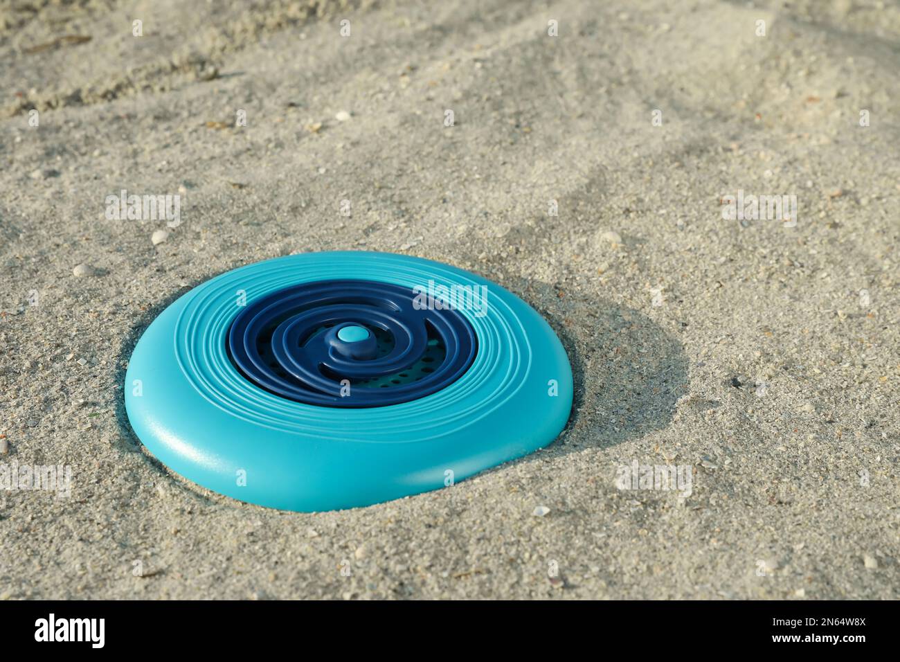 Blue plastic frisbee disc on sandy beach Stock Photo - Alamy