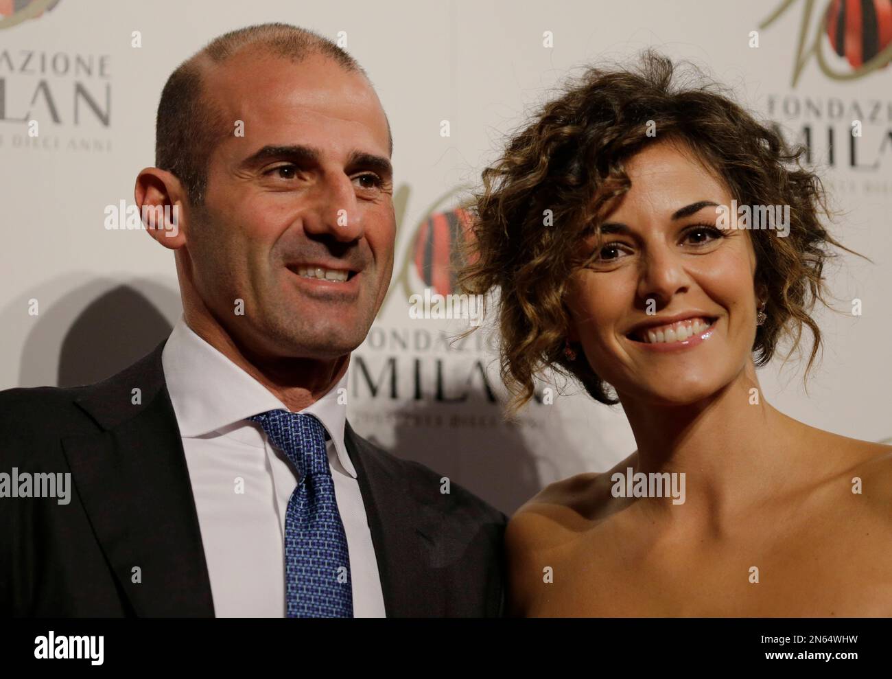 Italian former soccer player Giuseppe Pancaro is flanked by his wife ...