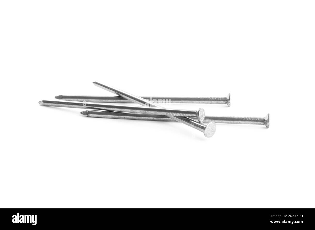 Sharp shiny metal nails on white background Stock Photo - Alamy