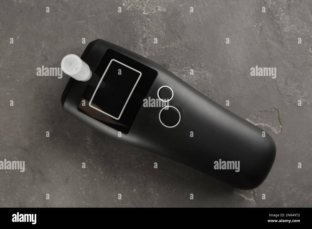 Modern breathalyzer with blank screen on grey stone table, top view ...