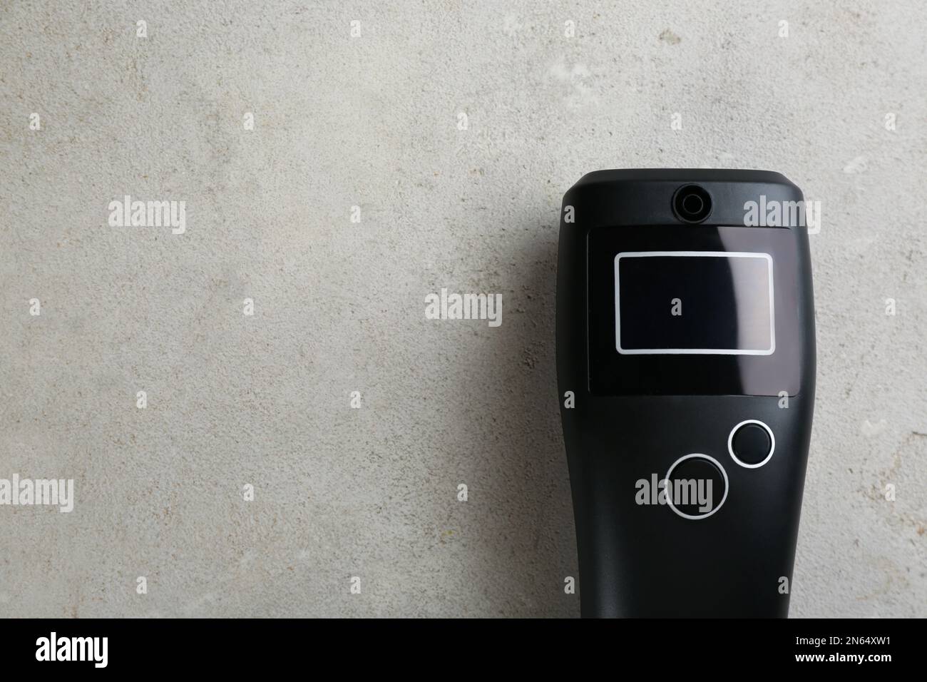 Modern breathalyzer with blank screen on light grey stone table, top ...