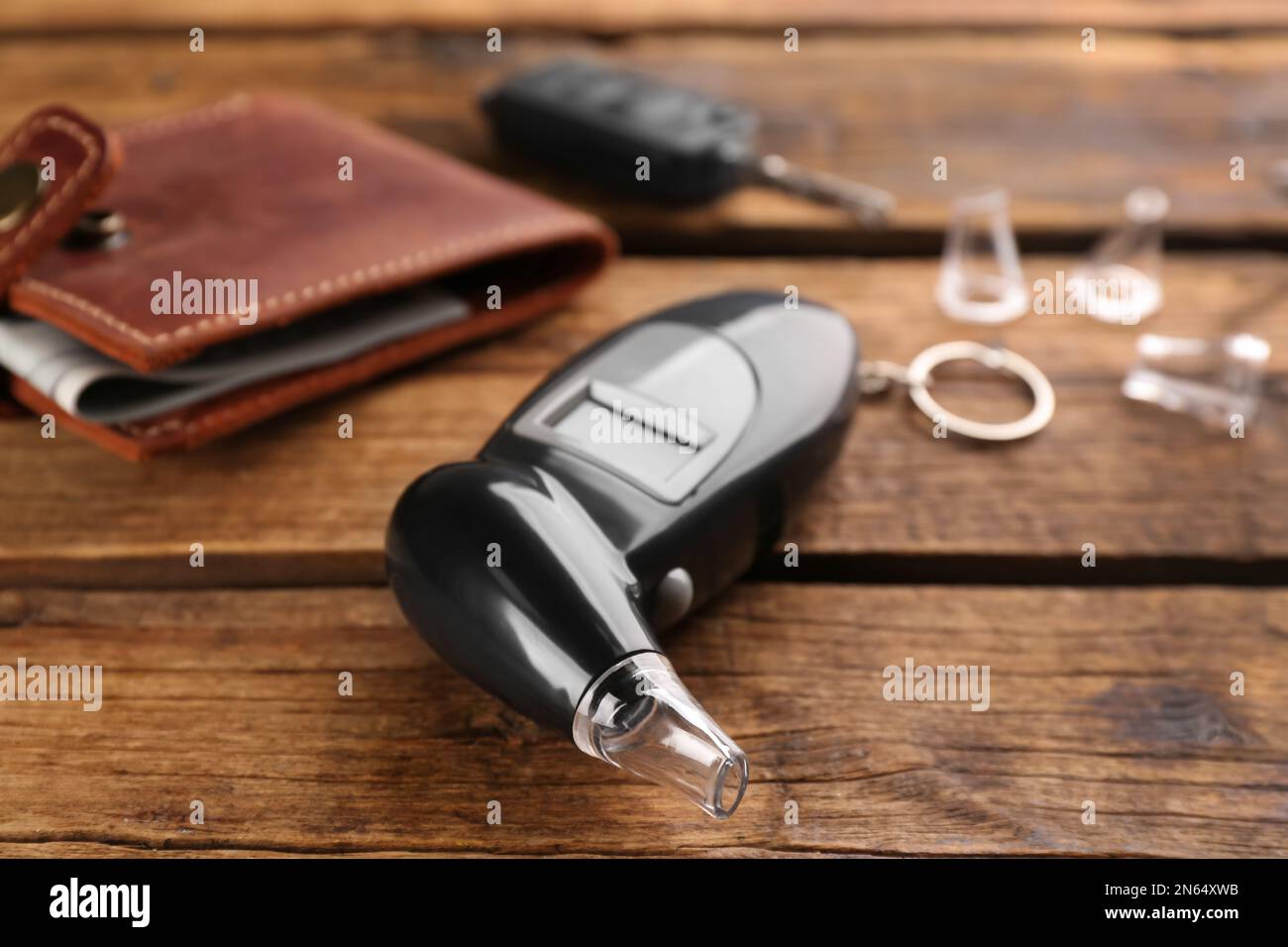 Modern breathalyzer with mouthpiece on wooden table Stock Photo - Alamy